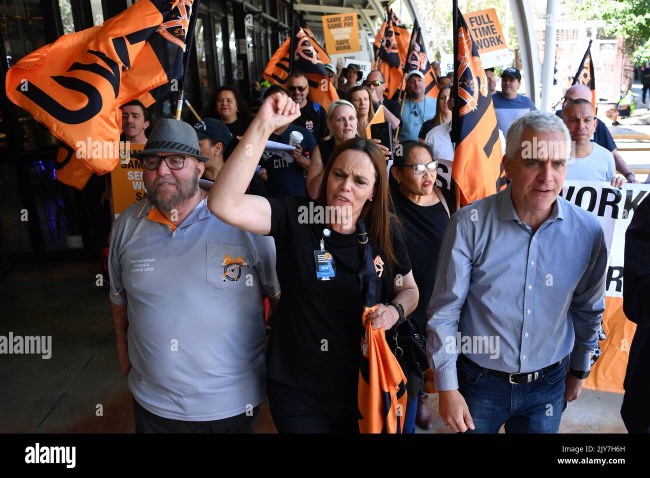 Airport workers hold placards as they protest unsafe and unfair working ...