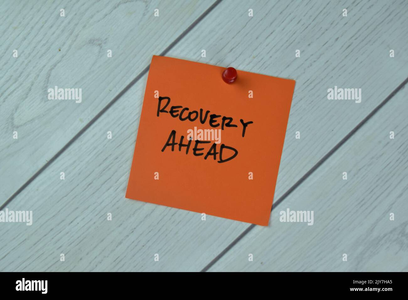 Concept of Recovery Ahead write on a book isolated on Wooden Table ...