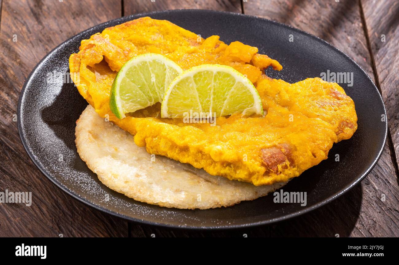 Breaded fish fillet - Traditional Colombian food Stock Photo - Alamy