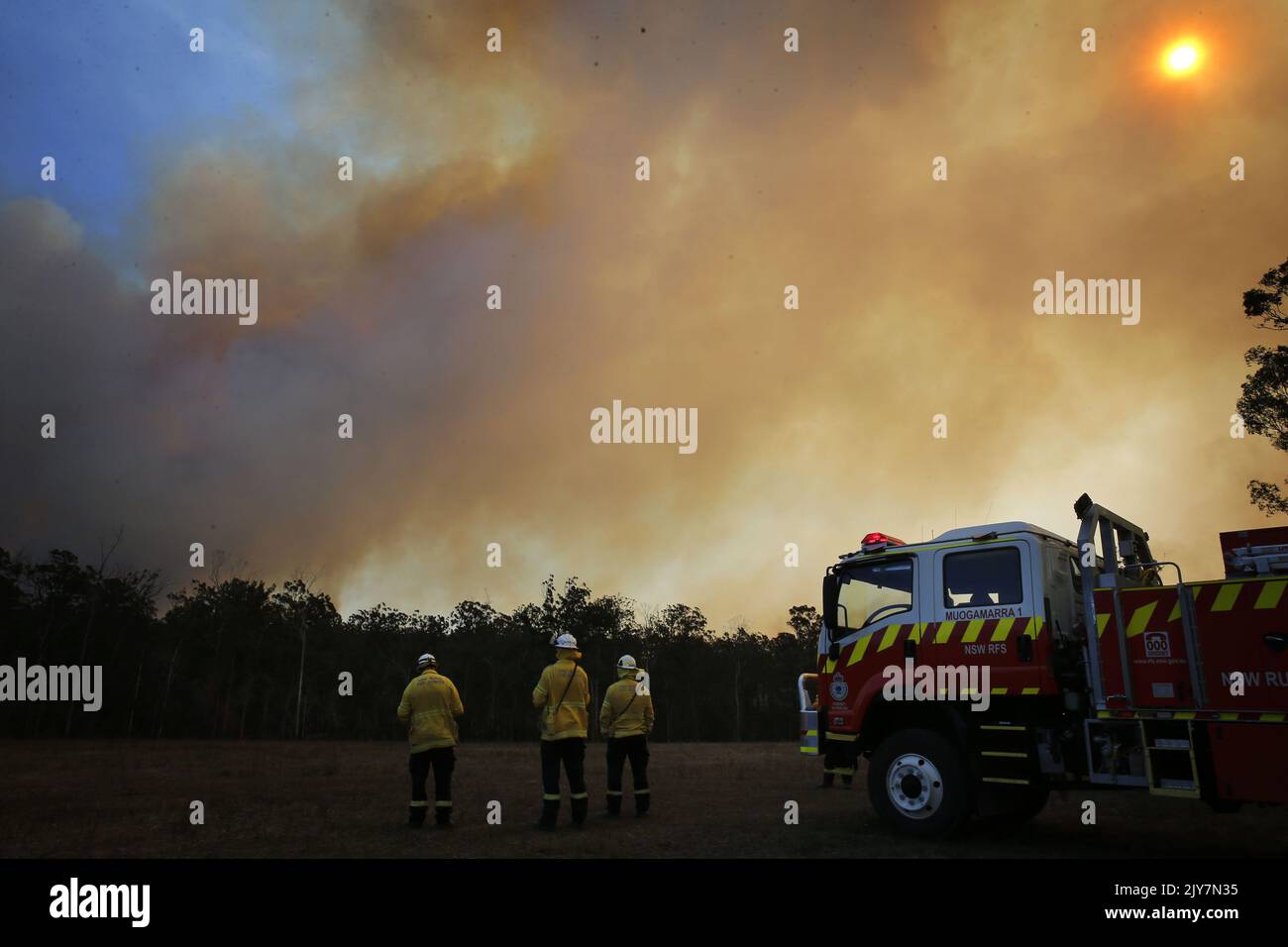 Firefighters wait for a fire at a property at Old Bar, Sunday, November ...