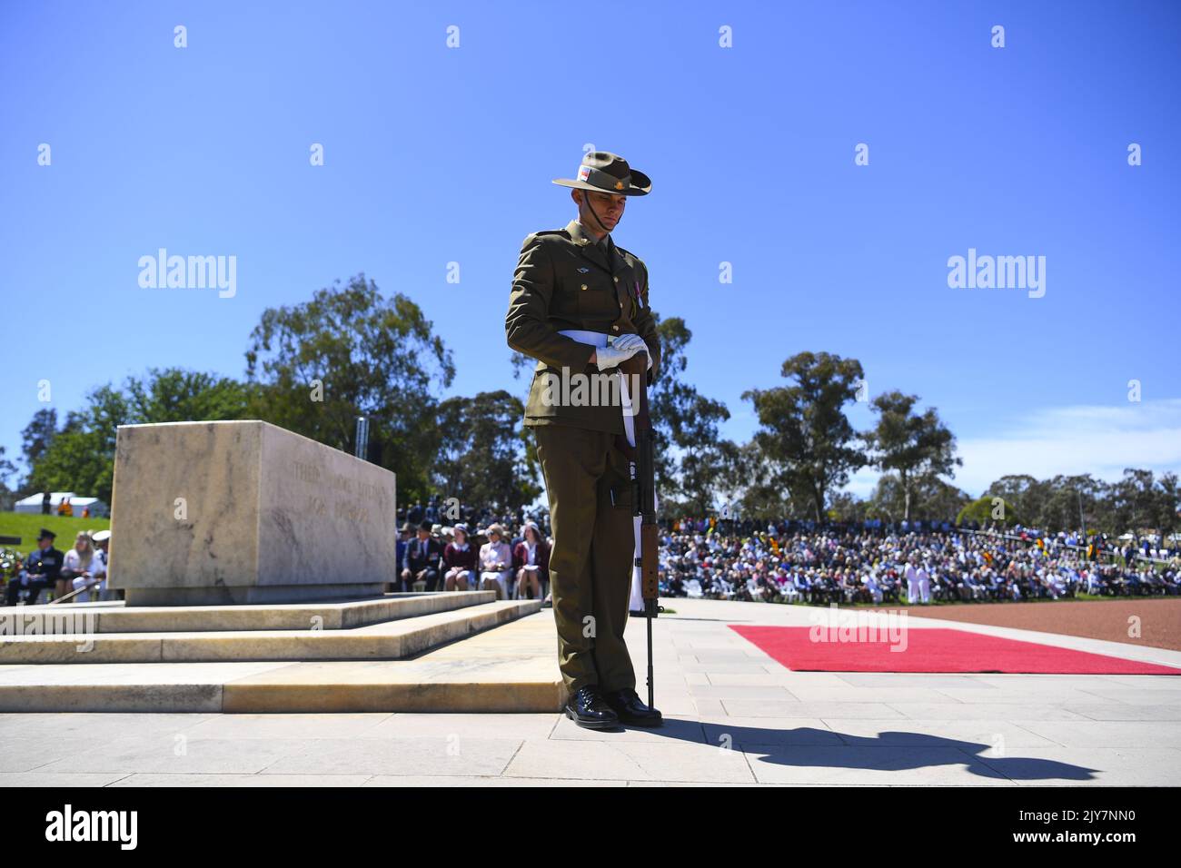 A member of the Catafalque Party is seen at the stone of remembrance ...