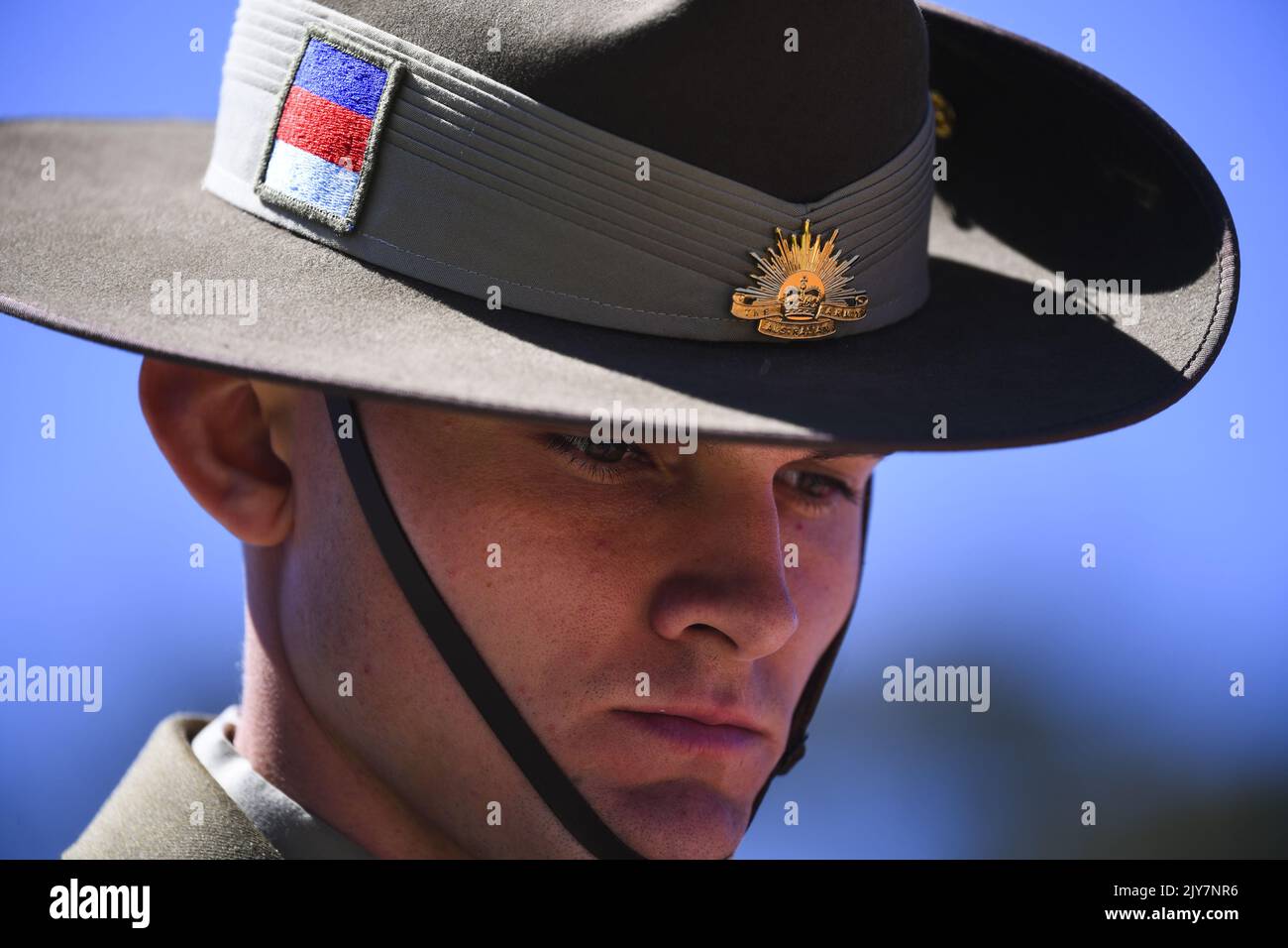 A member of the Catafalque Party is seen at the stone of remembrance ...