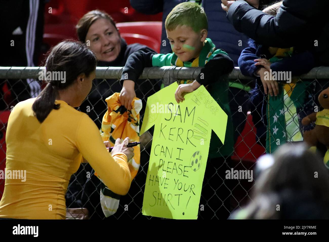 Sam Kerr of the Matildas gives Patrick Dobbin,6, her shirt during the ...