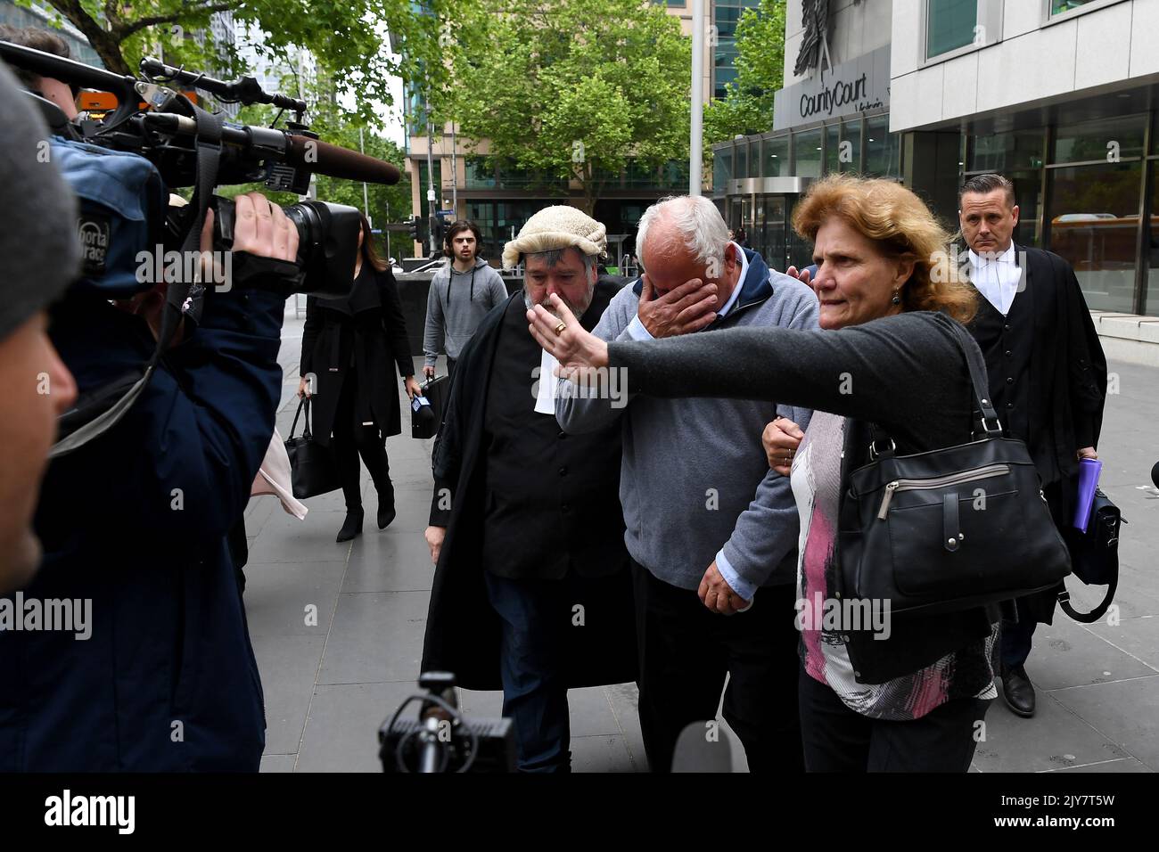 John Cowburn (3rd right) departs the County Court of Victoria ...