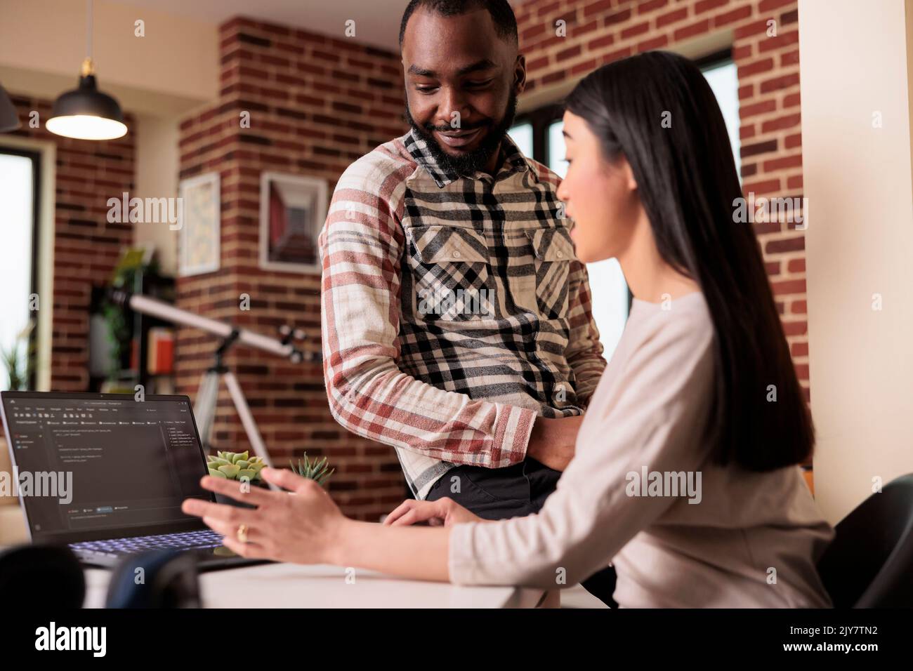 Programmers Couple Developing Encryption Code On Laptop Using Terminal Window With Html Script