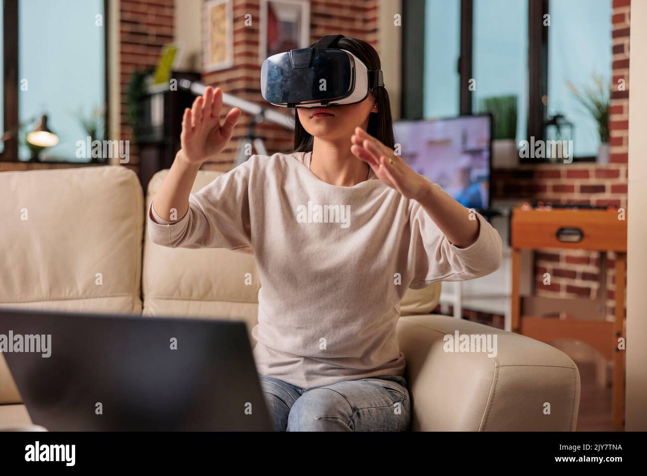 Happy asian woman enjoying wearing VR virtual reality headset, modern ...