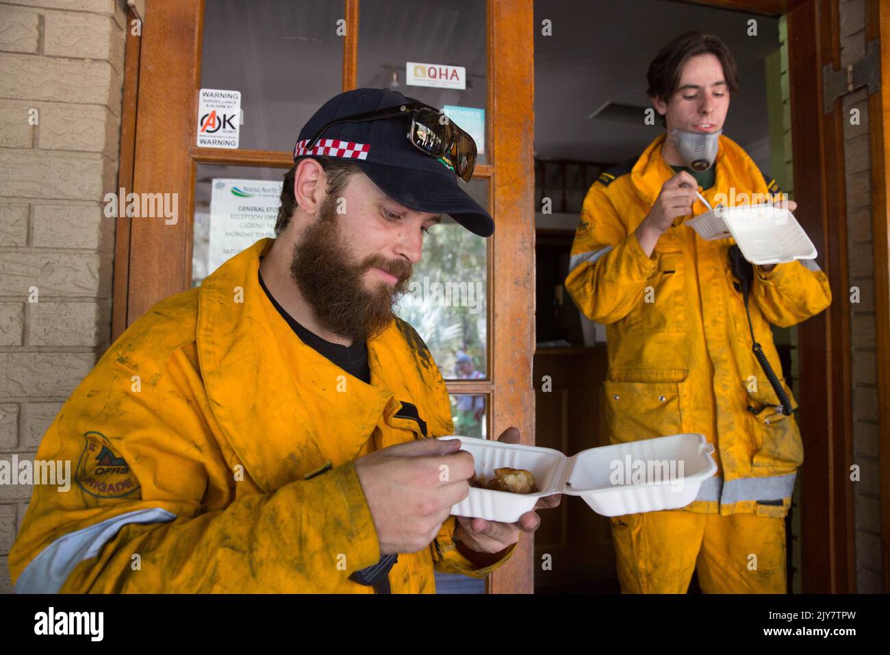 Firefighters eat lunch in the suburb of Noosa North Shore, in ...