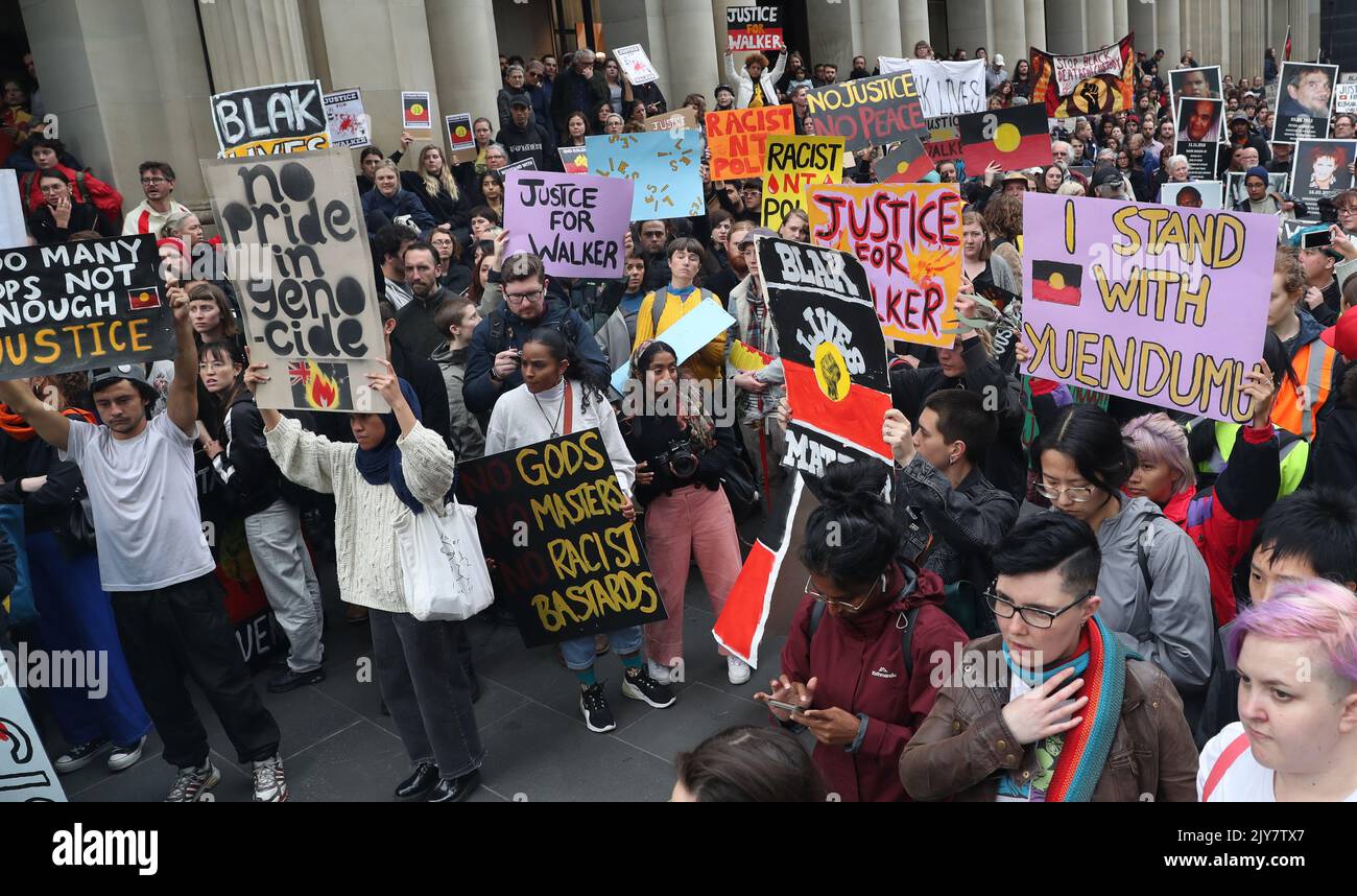 Aboriginal and Torres Strait Islanders and allies hold placards during ...