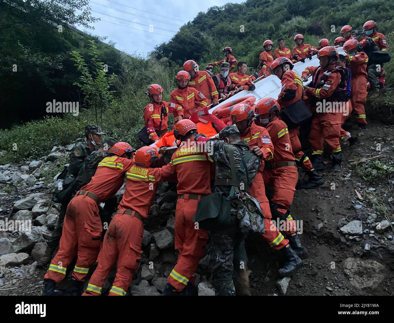 LUDING, CHINA - SEPTEMBER 7, 2022 - Fire and rescue personnel lift a ...