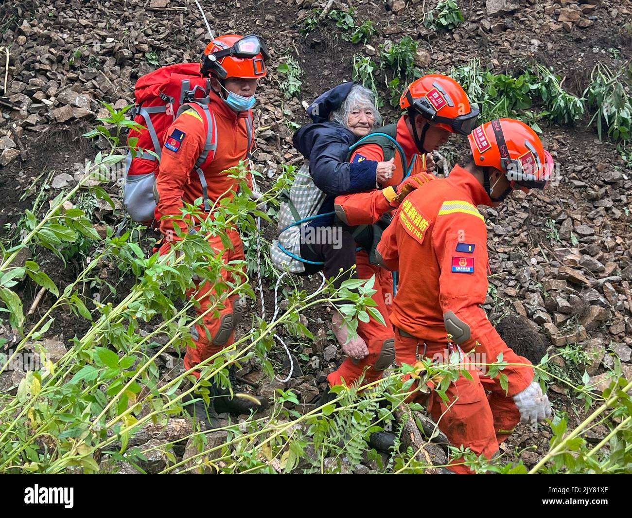 LUDING, CHINA - SEPTEMBER 7, 2022 - Rescuers move people with poor legs ...
