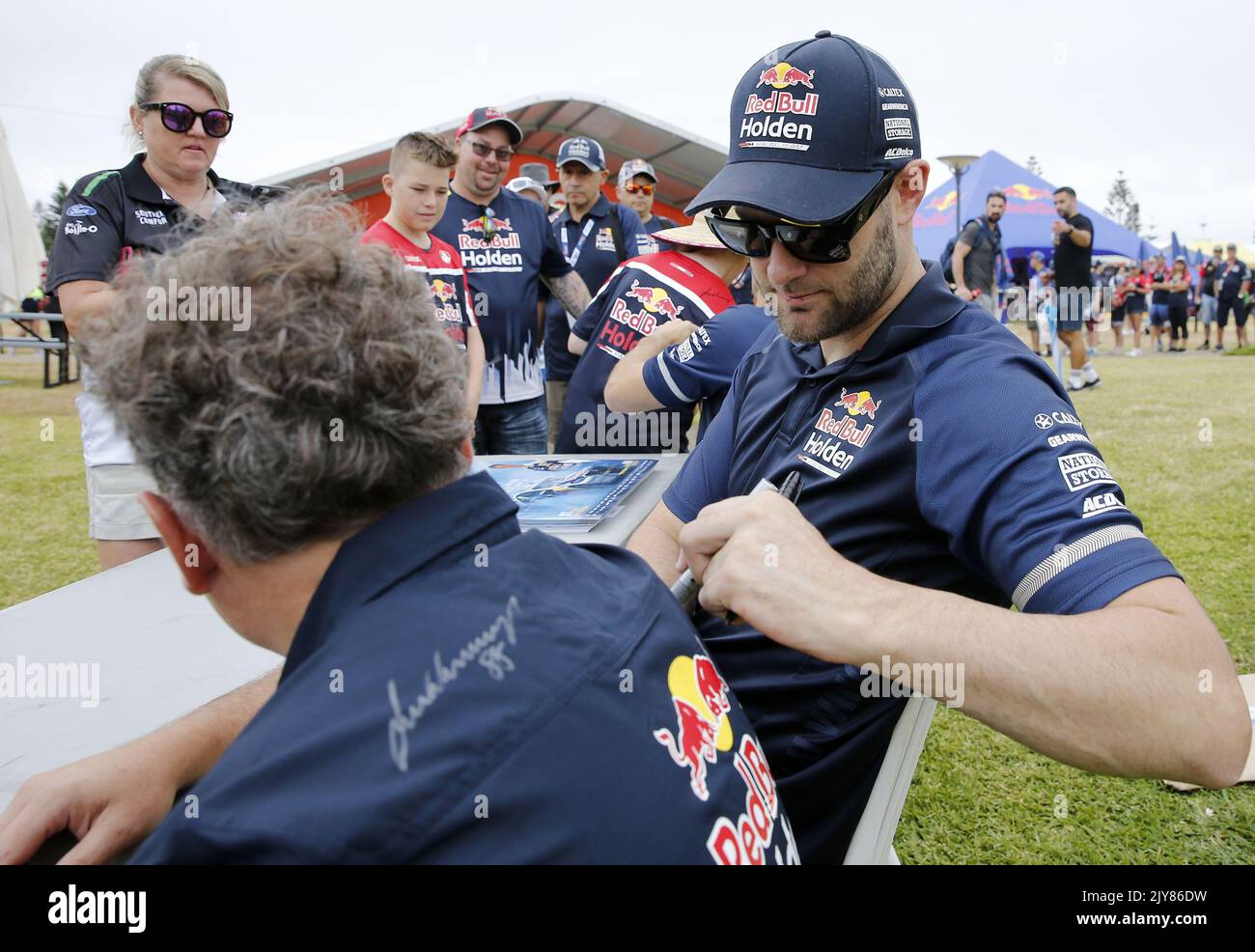 Shane van Gisbergen signs the shirt of a Supercars fan during the ...