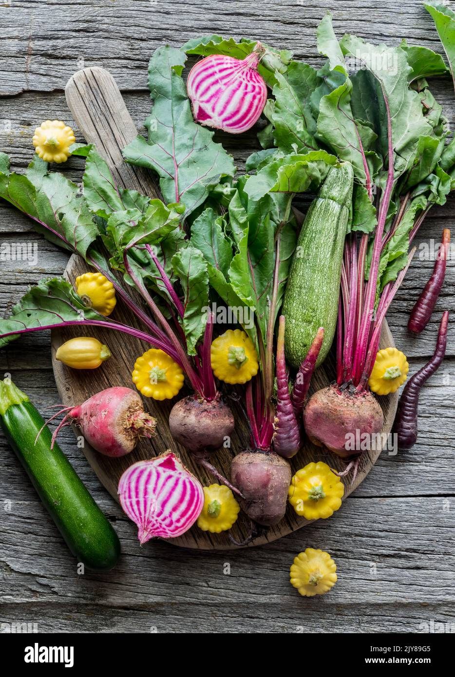 Top down view of fresh root vegetables including beets, zucchini and ...
