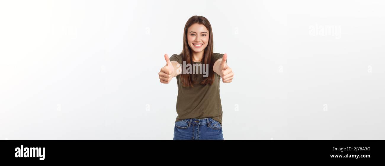 Closeup portrait of a beautiful young woman showing thumbs up sign ...