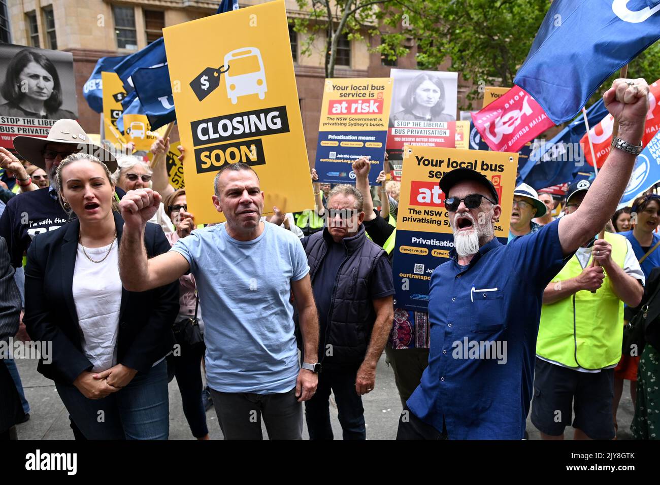 Protestors hold placards during the Keep Our Buses Public Rally in ...