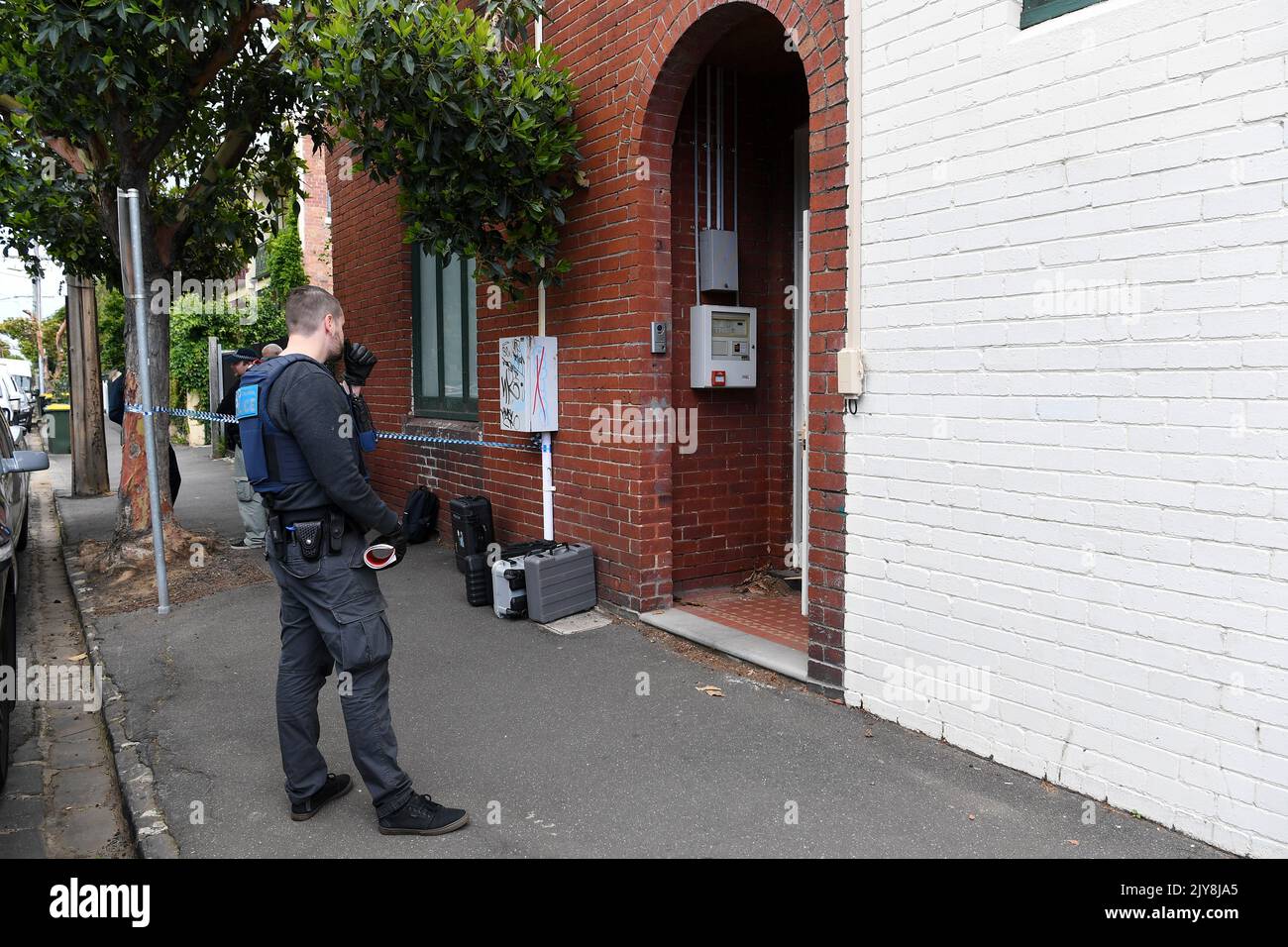 Australian Federal Police are seen outside a property in Elwood ...