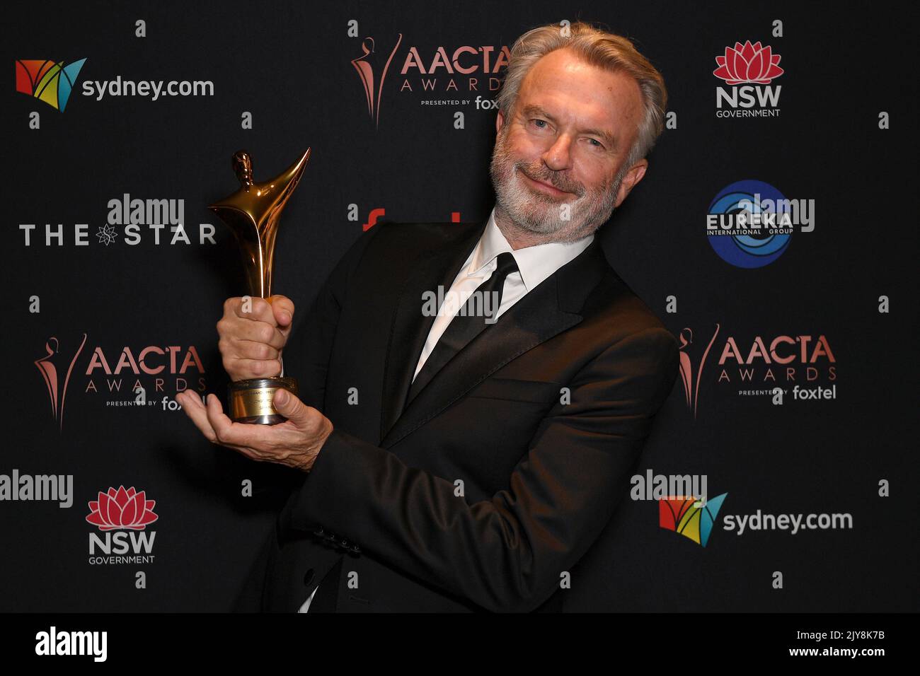 Sam Neill poses for a photograph after winning the Longford Lyell Award ...