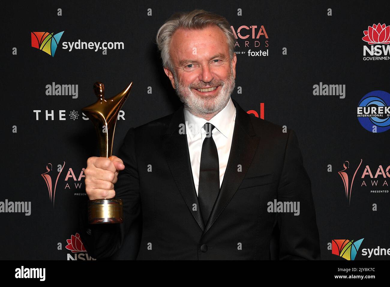 Sam Neill poses for a photograph after winning the Longford Lyell Award ...