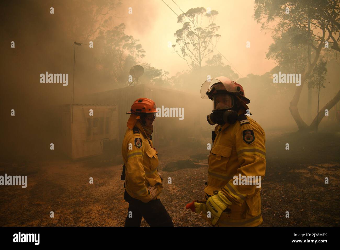 NSW Rural Fire Service and Fire and Rescue NSW crews work to protect a ...