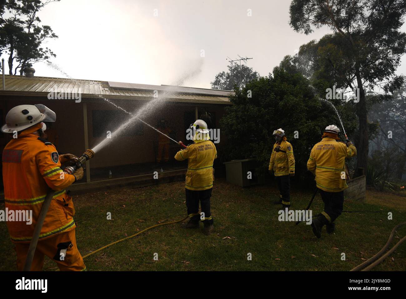 NSW Rural Fire Service and Fire and Rescue NSW crews work to protect a ...