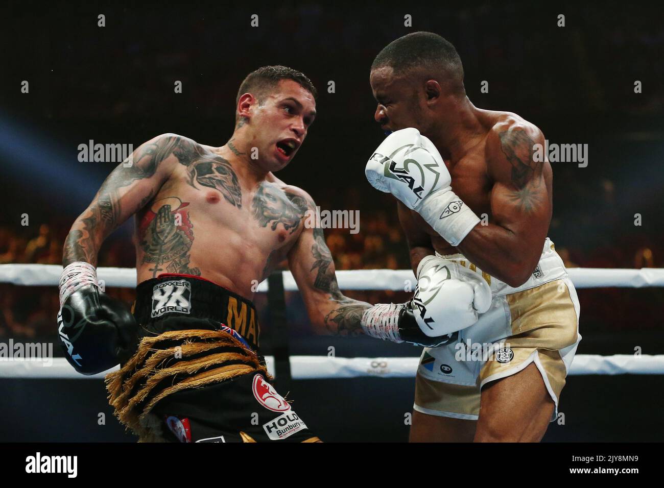 Bruno Tarimo and Nathaniel May compete in the Men's Super Featherweight fight during their ...