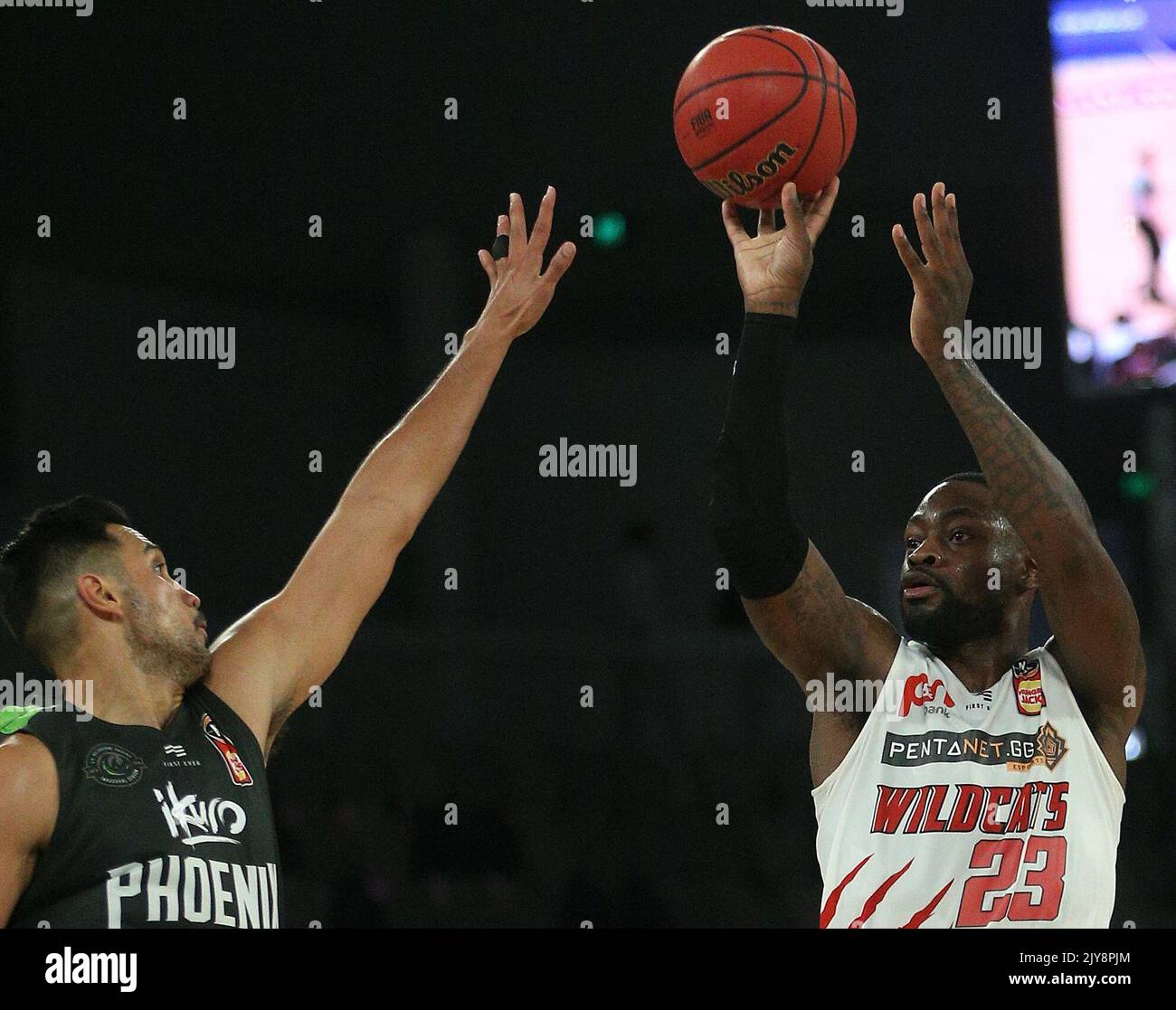 Terrico White of Perth (right) shoots over Tai Wesley of the Phoenix ...