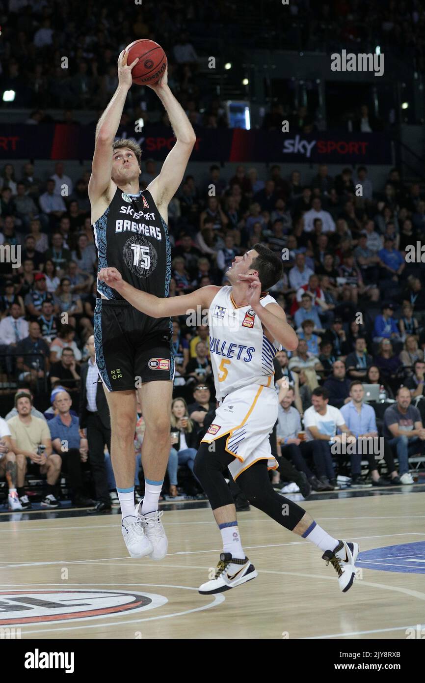Robert Loe of the Breakers is challenged by Jason Cadee of the Bullets ...
