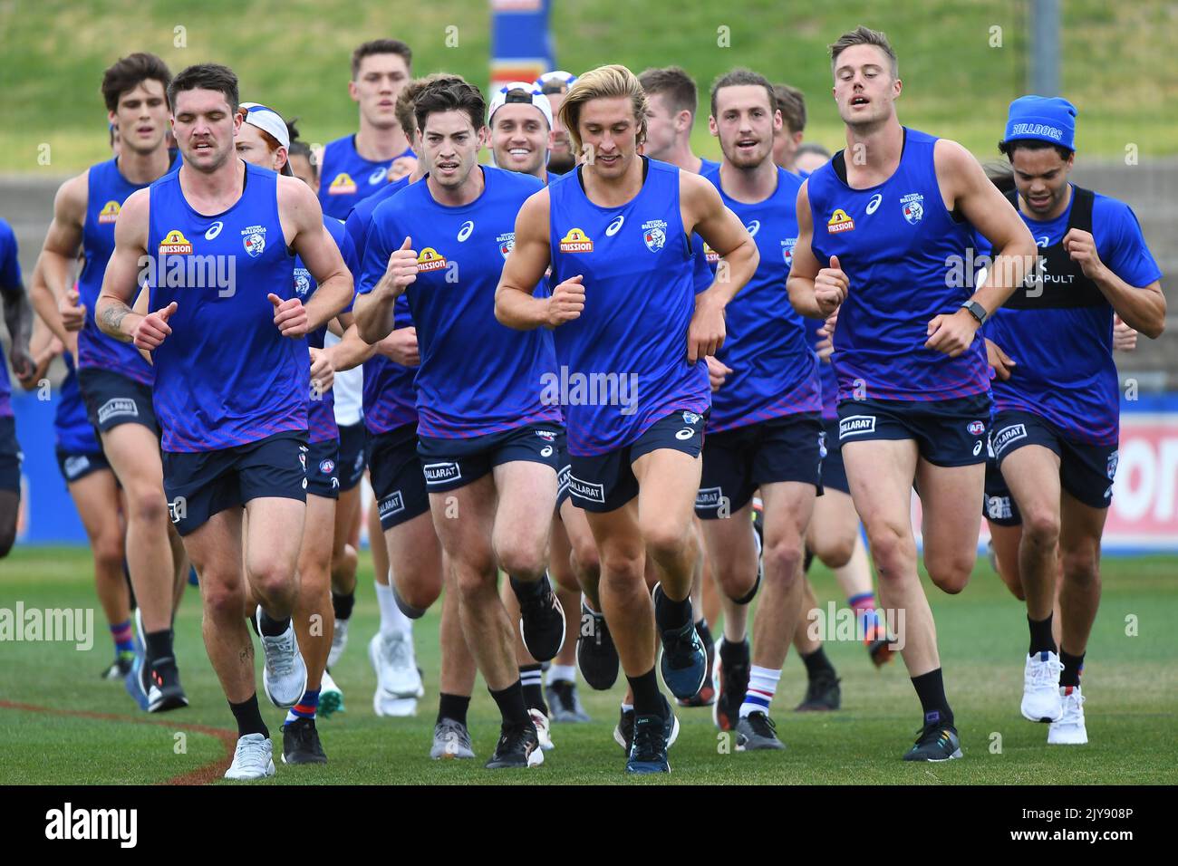 Western Bulldogs AFL players warm up during a joint training session at ...
