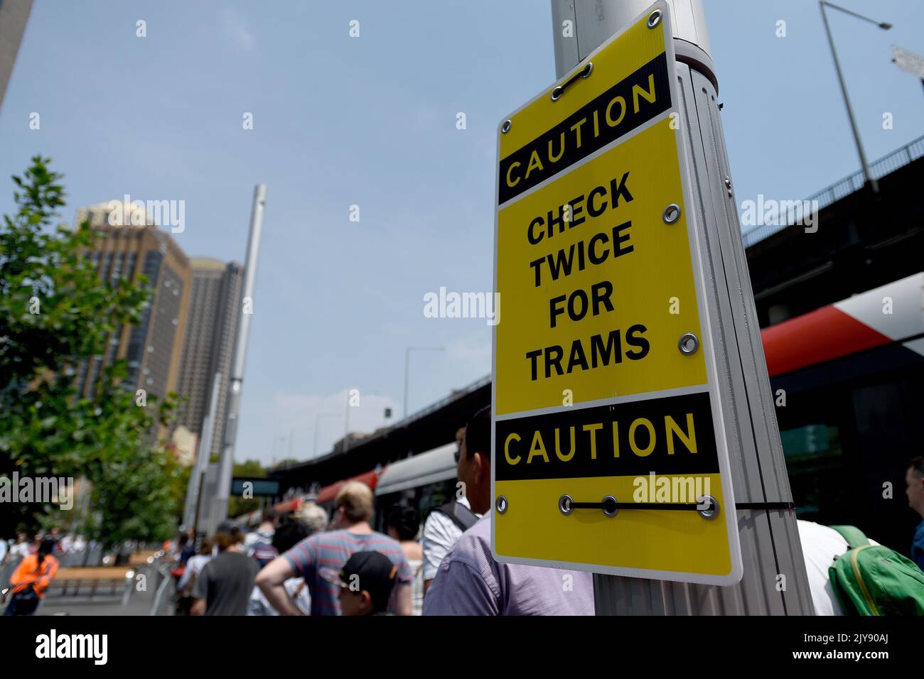 A caution sign is seen as passengers board the new light rail after it ...