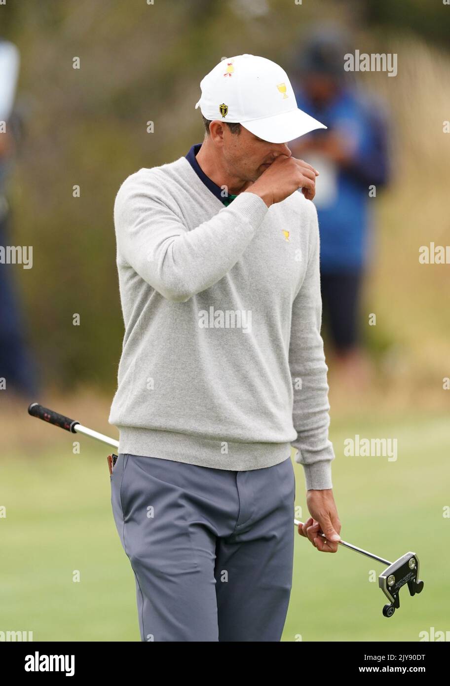 Adam Scott of Australia and the International team reacts after missing ...
