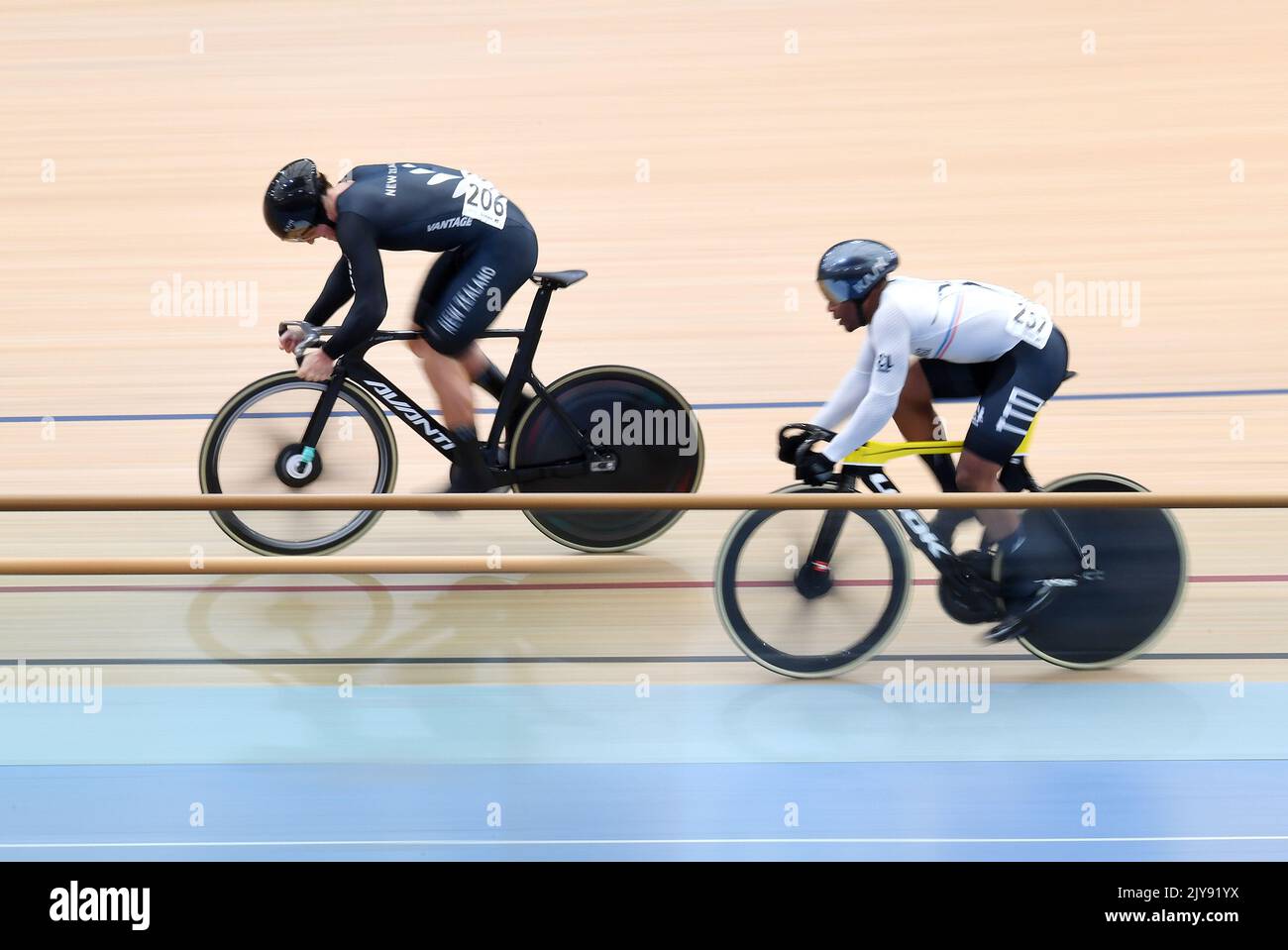 New Zealand's Ethan Mitchell (left) races Paul Nicholas of Trinidad and ...