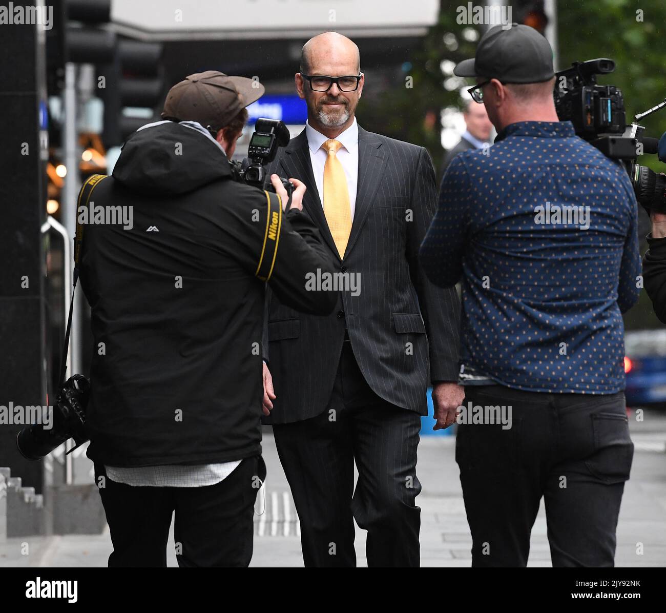 Former Victoria Police commissioner Simon Overland (centre) arrives at ...