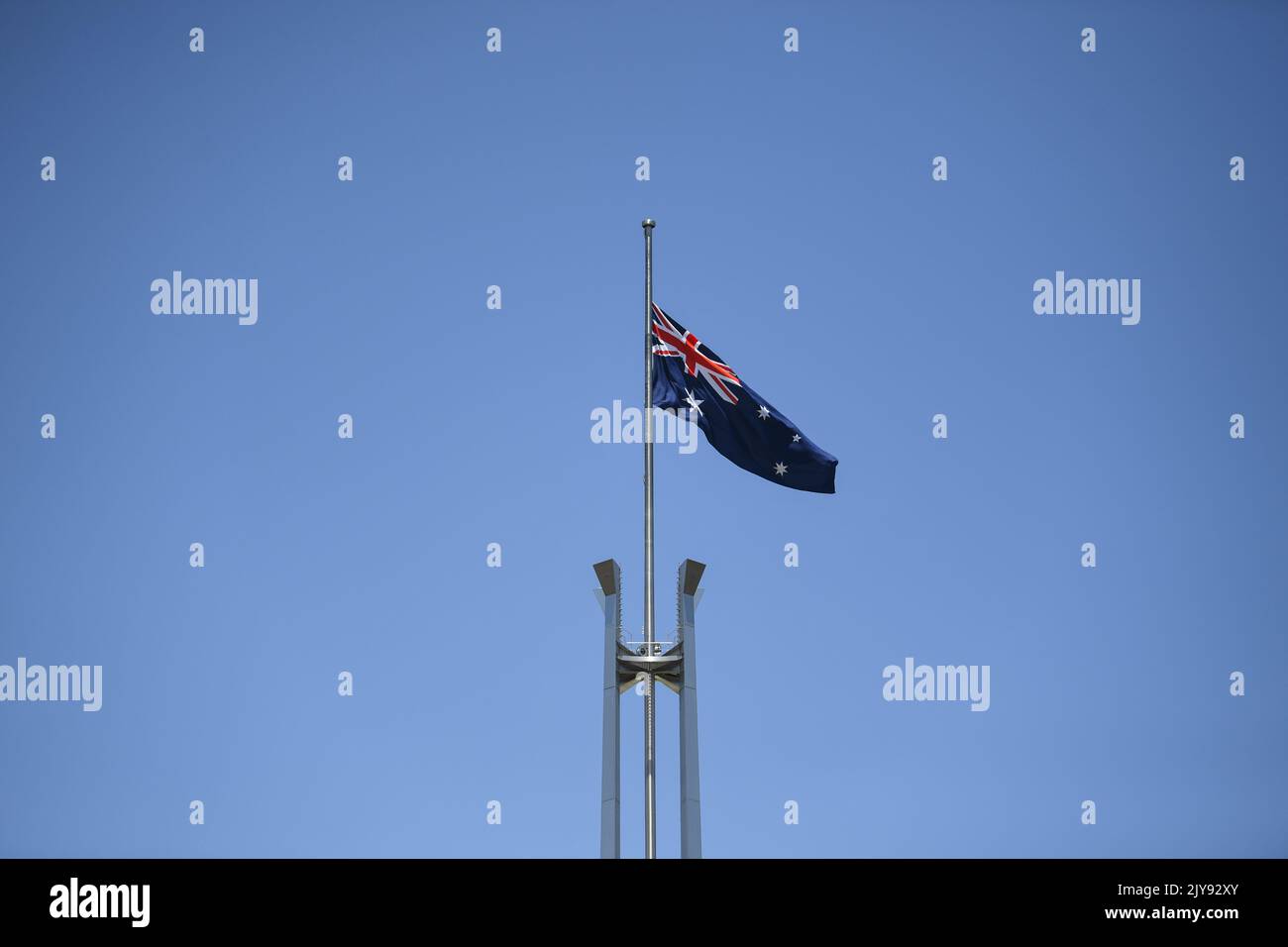The Australian flag is seen flying at half mast to honour the victims ...