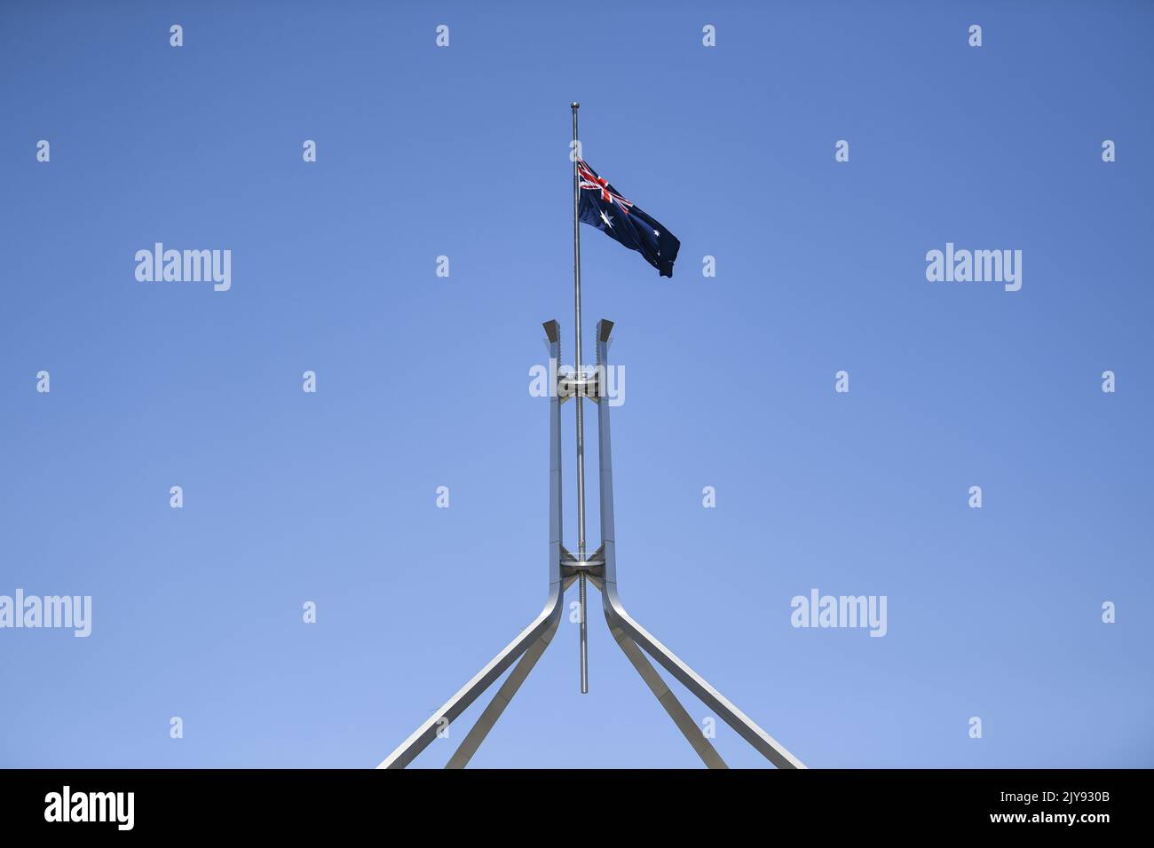 The Australian flag is seen flying at half mast to honour the victims ...