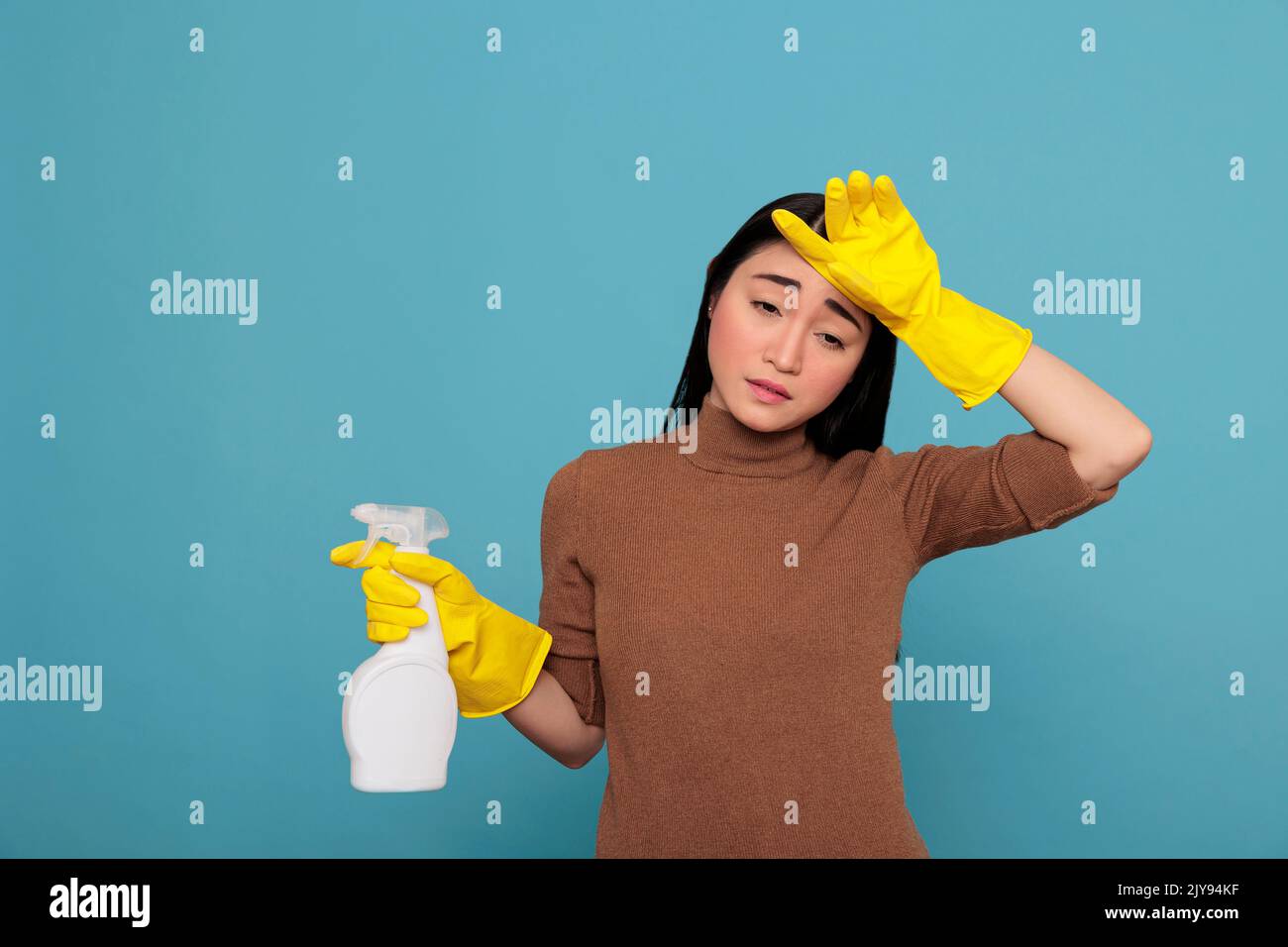 Tired frustrated and unhappy asian housewife from all the cleaning ...