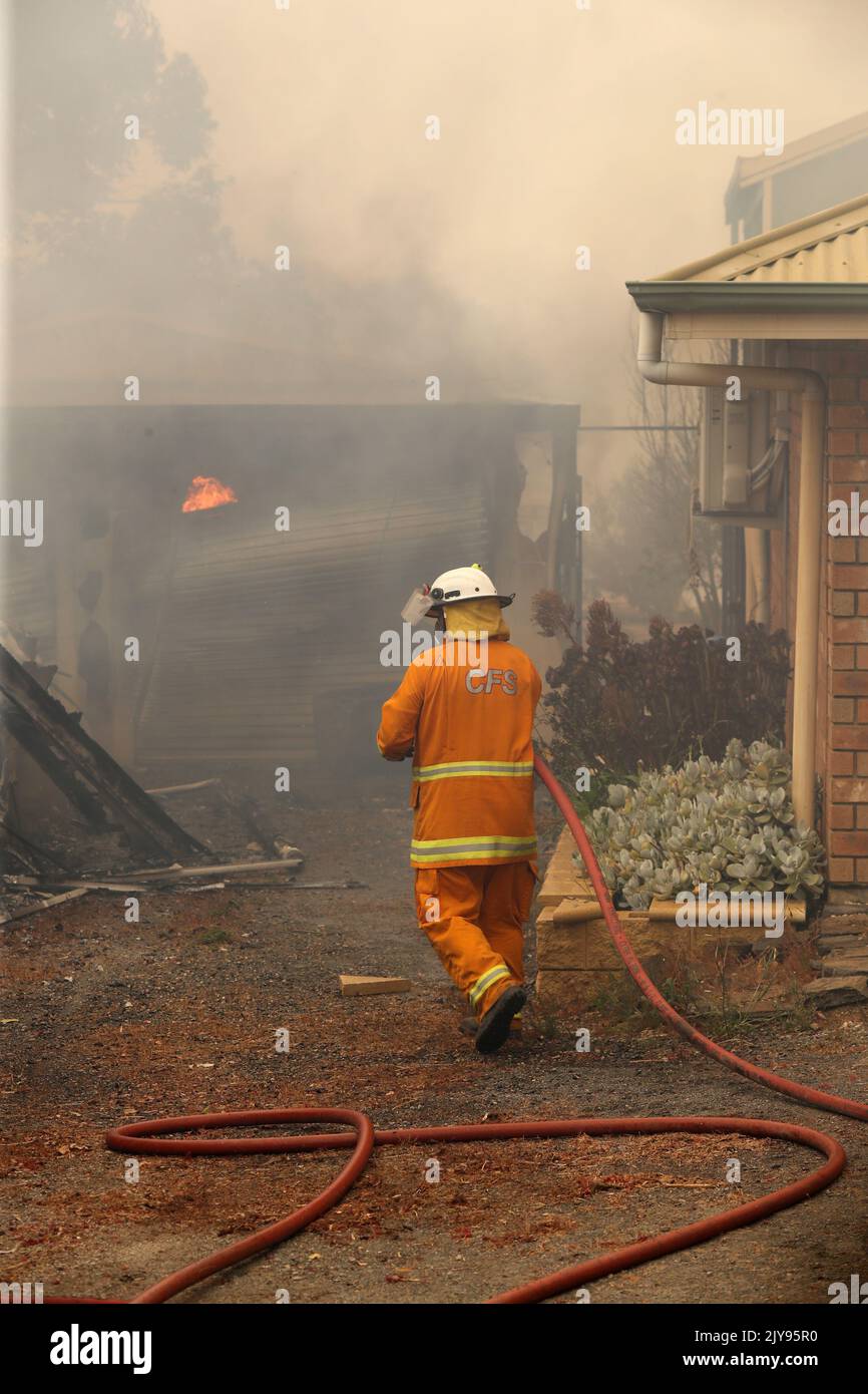 CFS firefighters put out fires on Jacaranda Drive at Woodside in the ...