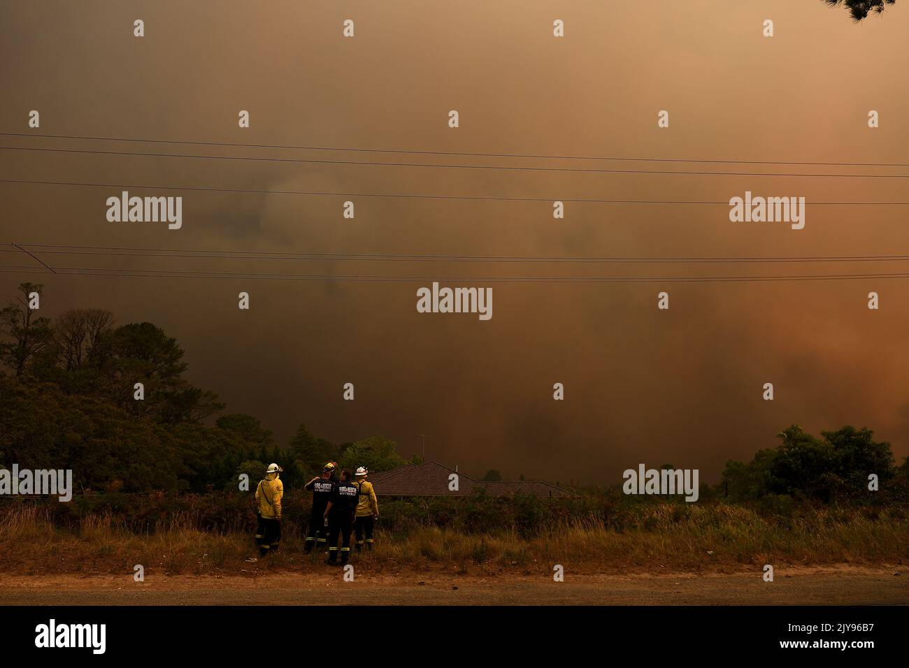 NSW Rural Fire Service and Fire and Rescue NSW firefighters watch on as ...