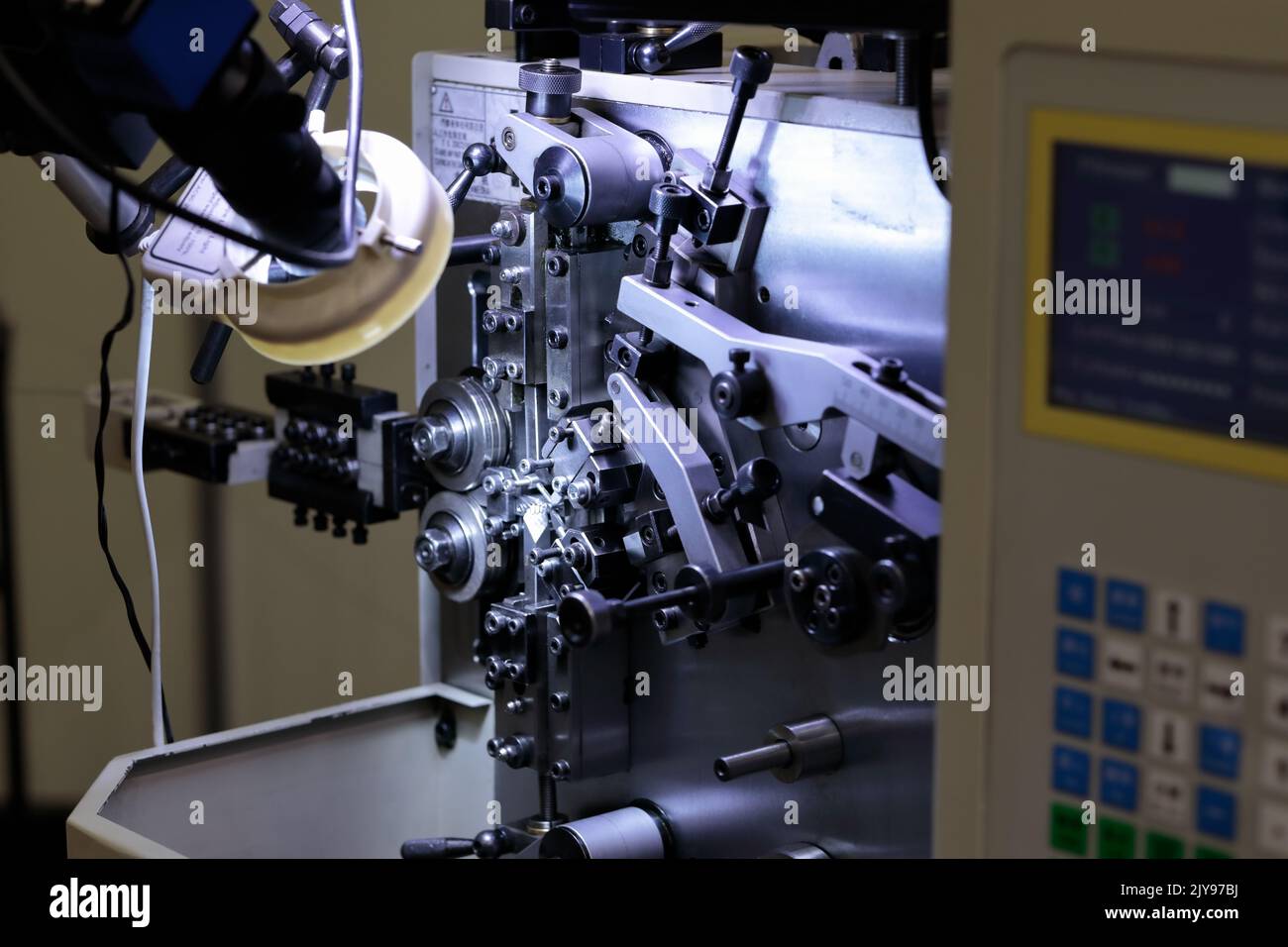 Automatic industrial CNC spring coiling machine. Selective focus Stock ...
