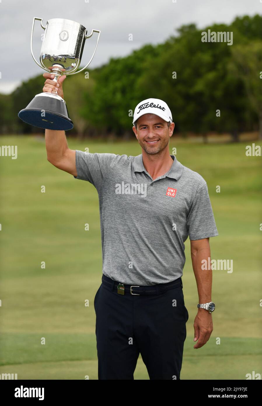 Australian golfer Adam Scott poses with the trophy after winning the ...