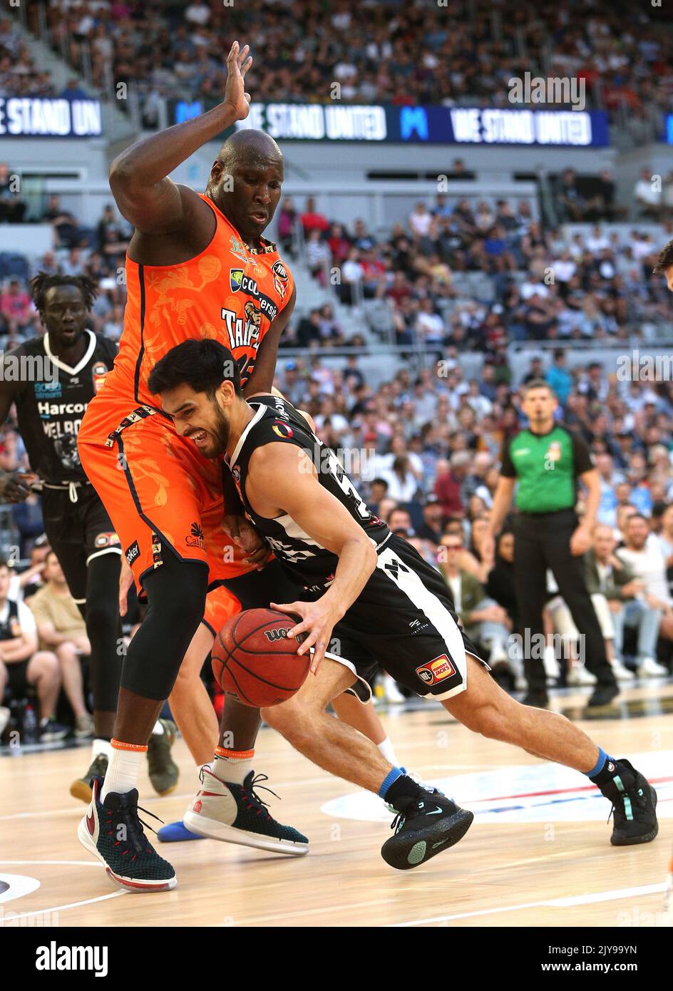Shea Ili of Melbourne United (right) contests with Nathan Jawai of ...