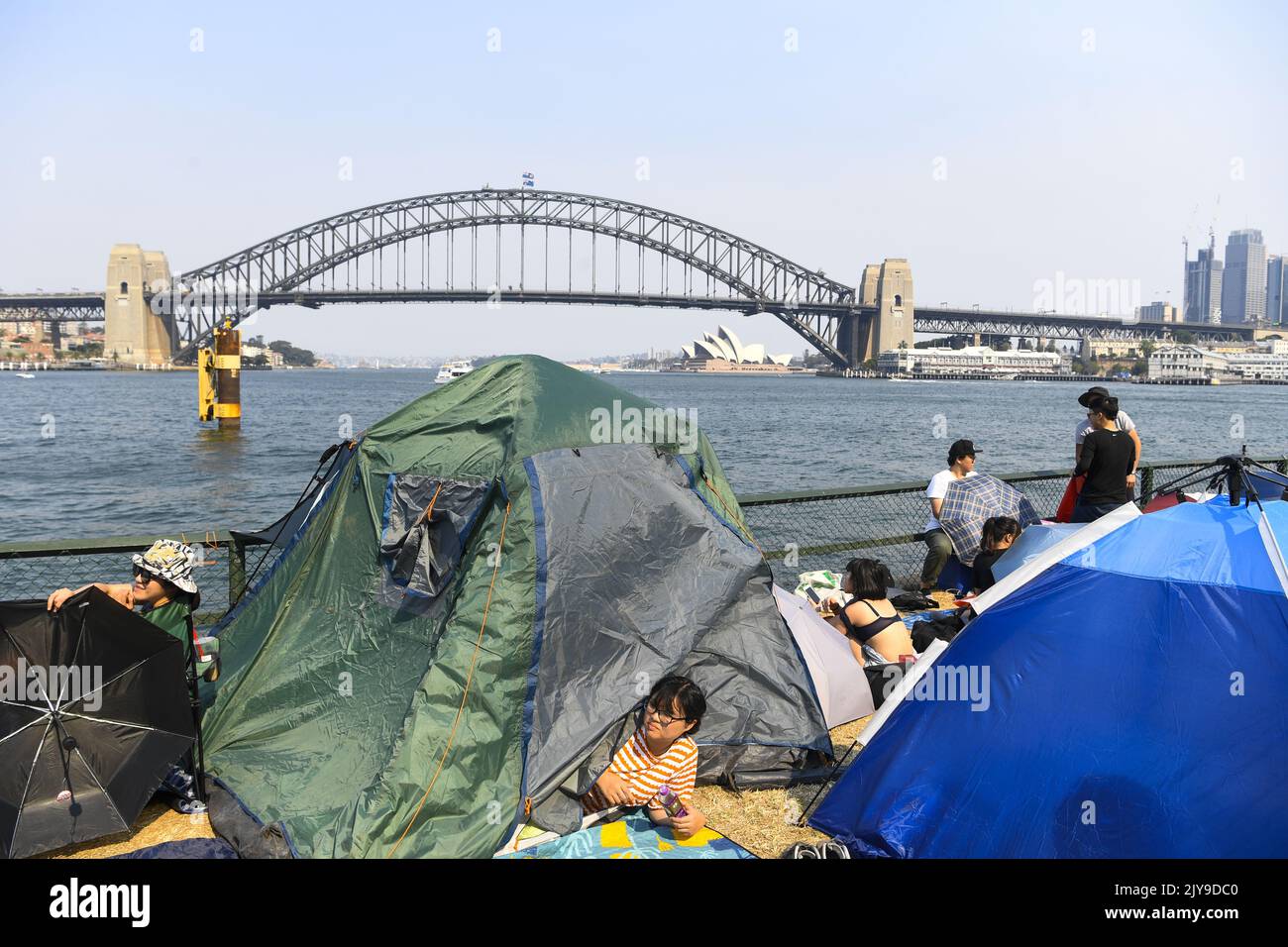 Revellers wait at Blues Point Reserve ahead of the Year's Eve ...