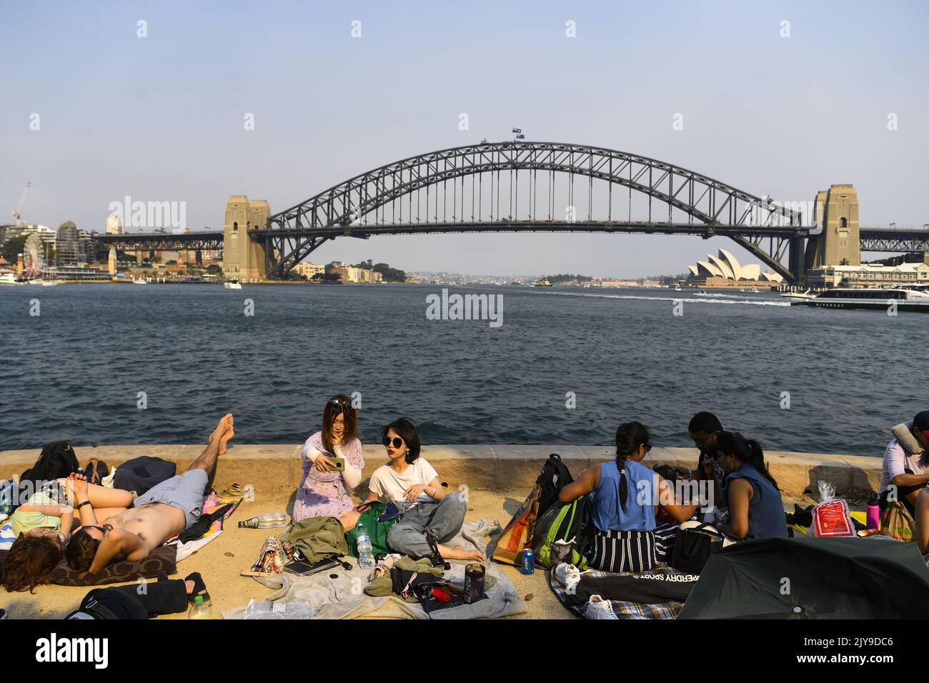 Revellers wait at Blues Point Reserve ahead of the Year's Eve ...