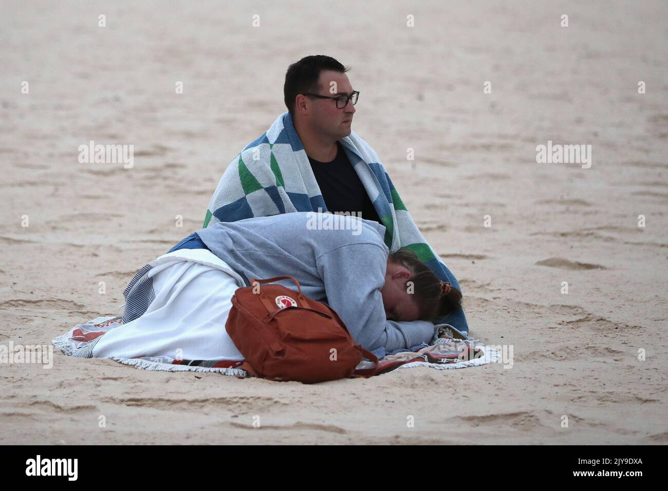 Revellers rest at Bondi Beach in Sydney, Wednesday, January 1, 2020 ...