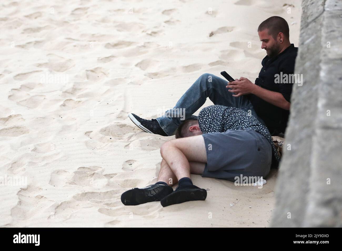 Revellers rest at Bondi Beach in Sydney, Wednesday, January 1, 2020 ...