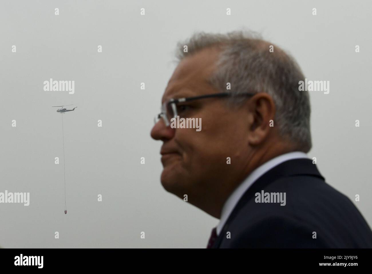 POOL A fire fighting helicopter is seen behind Australian Prime ...