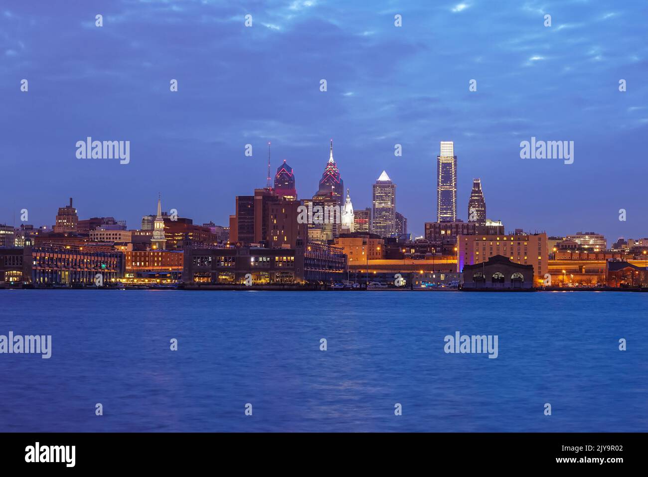 Philadelphia skyline reflected in the Delaware river under a twilight ...