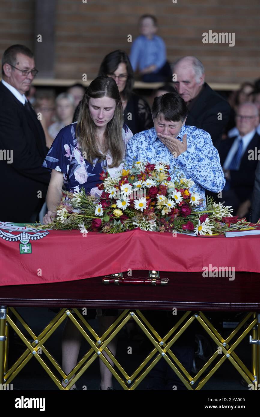 Sam’s widow Megan, and mum, Christine place flowers on the casket ...