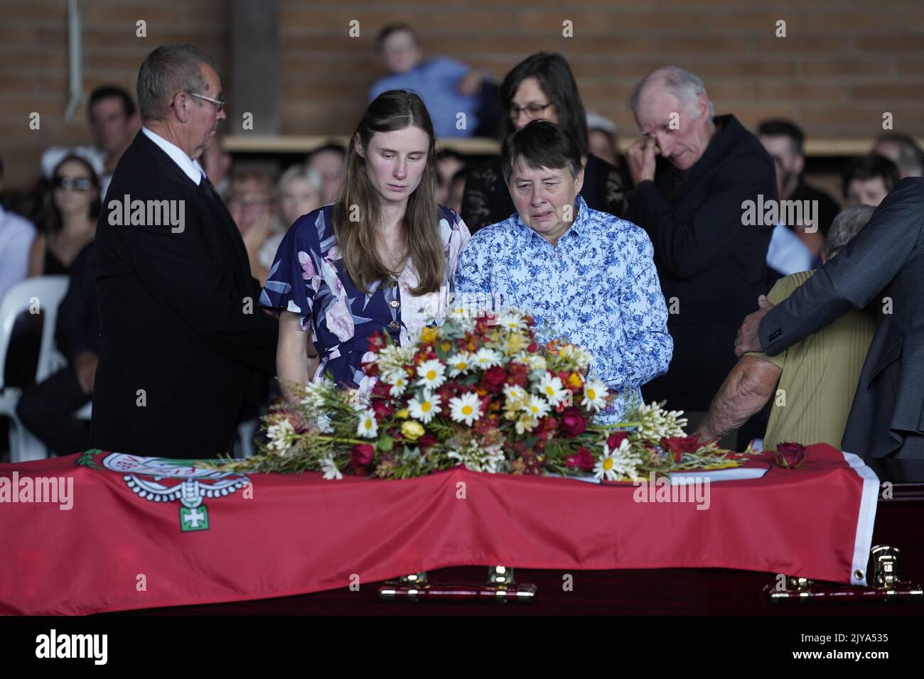 Sam’s widow, Megan, and mum, Christine place flowers on the casket ...