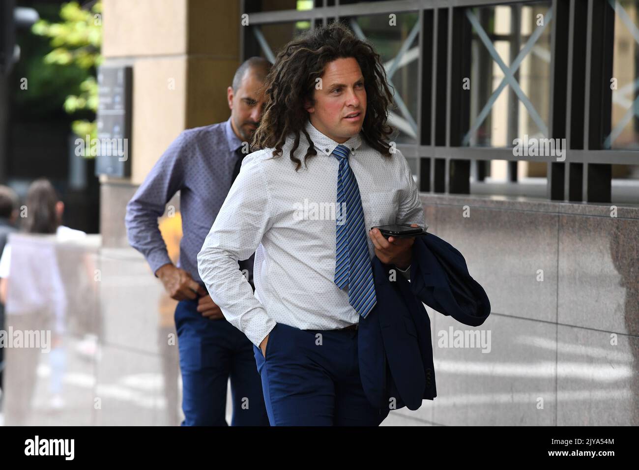 Edward Buczak (right) arrives to the Melbourne Magistrates Court in ...