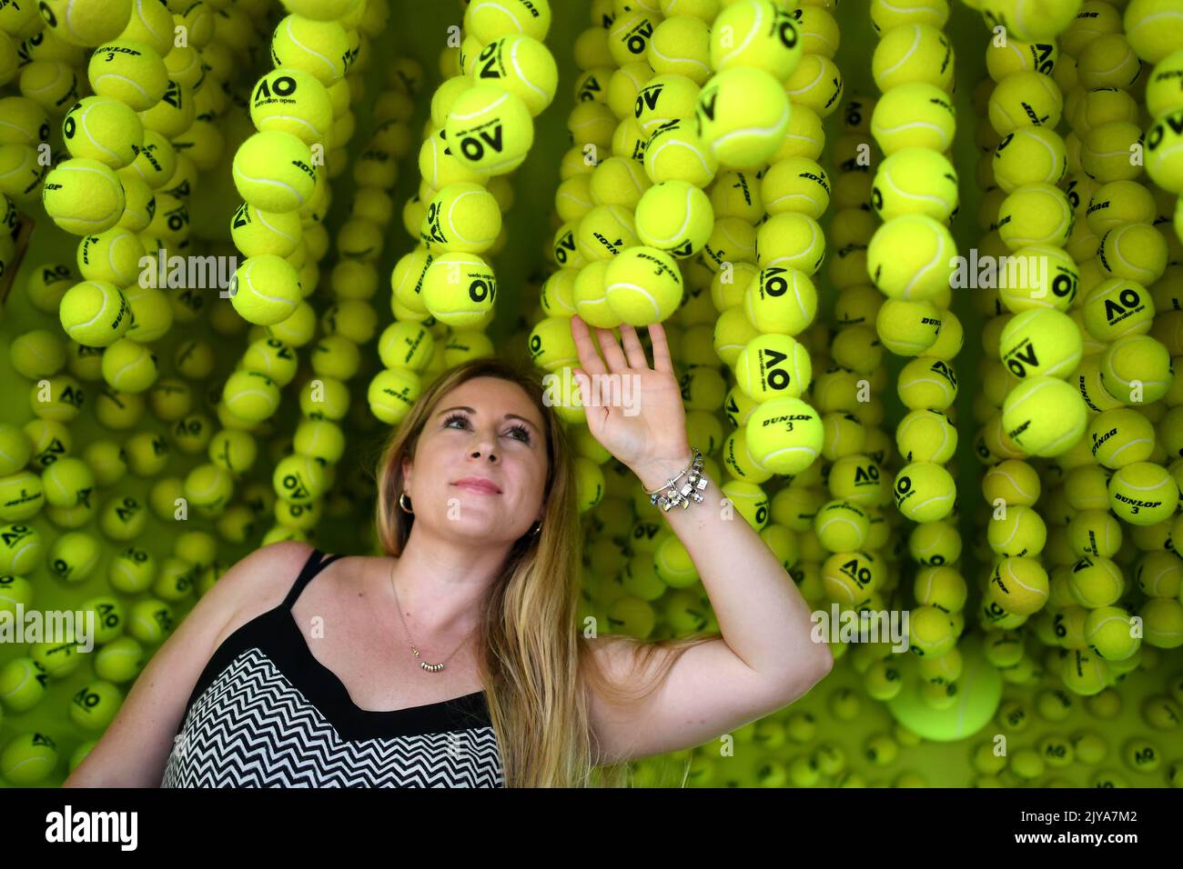 A spectator poses for a photgraph on day one of the Australian Open ...