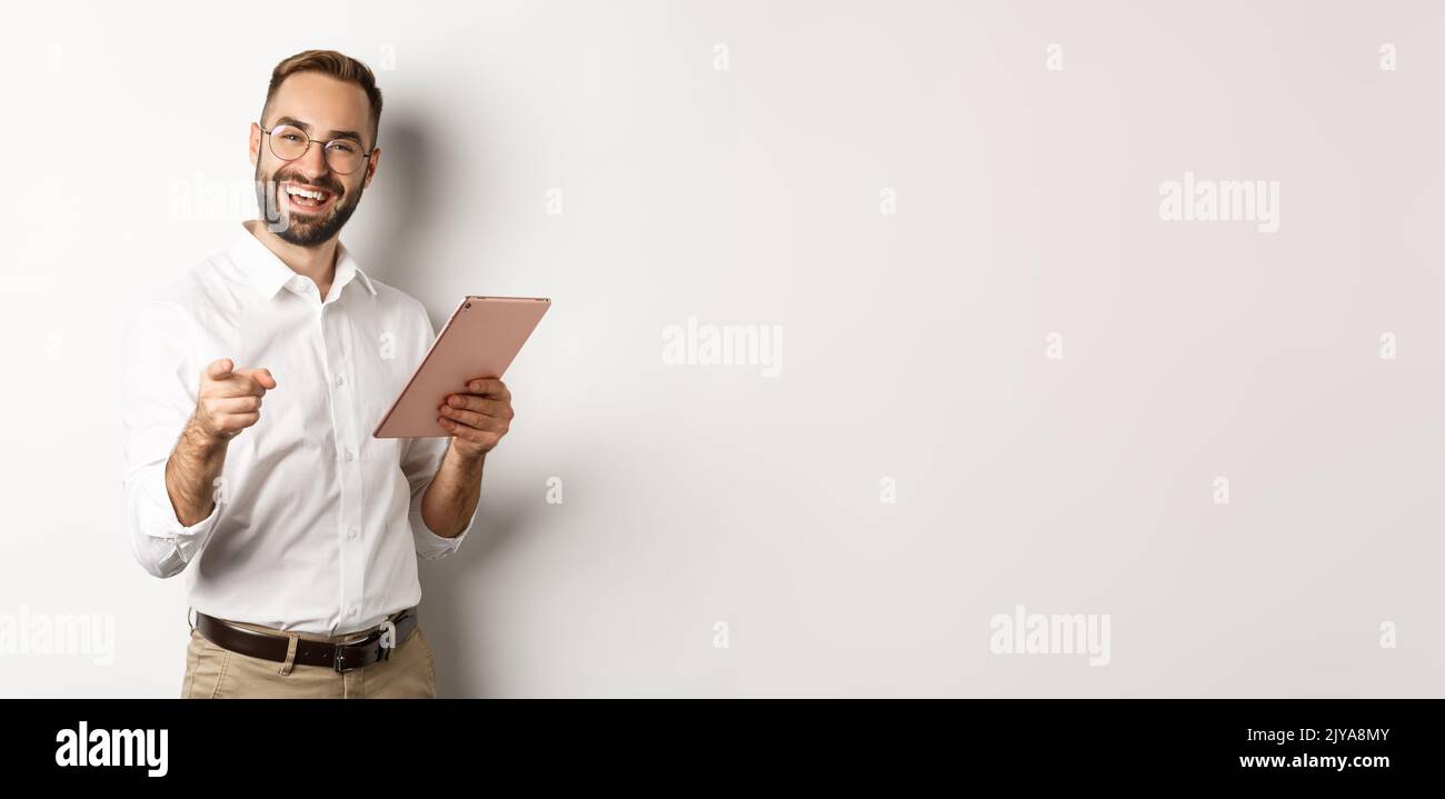 Happy and satisfied boss praising good job, reading on digital tablet ...